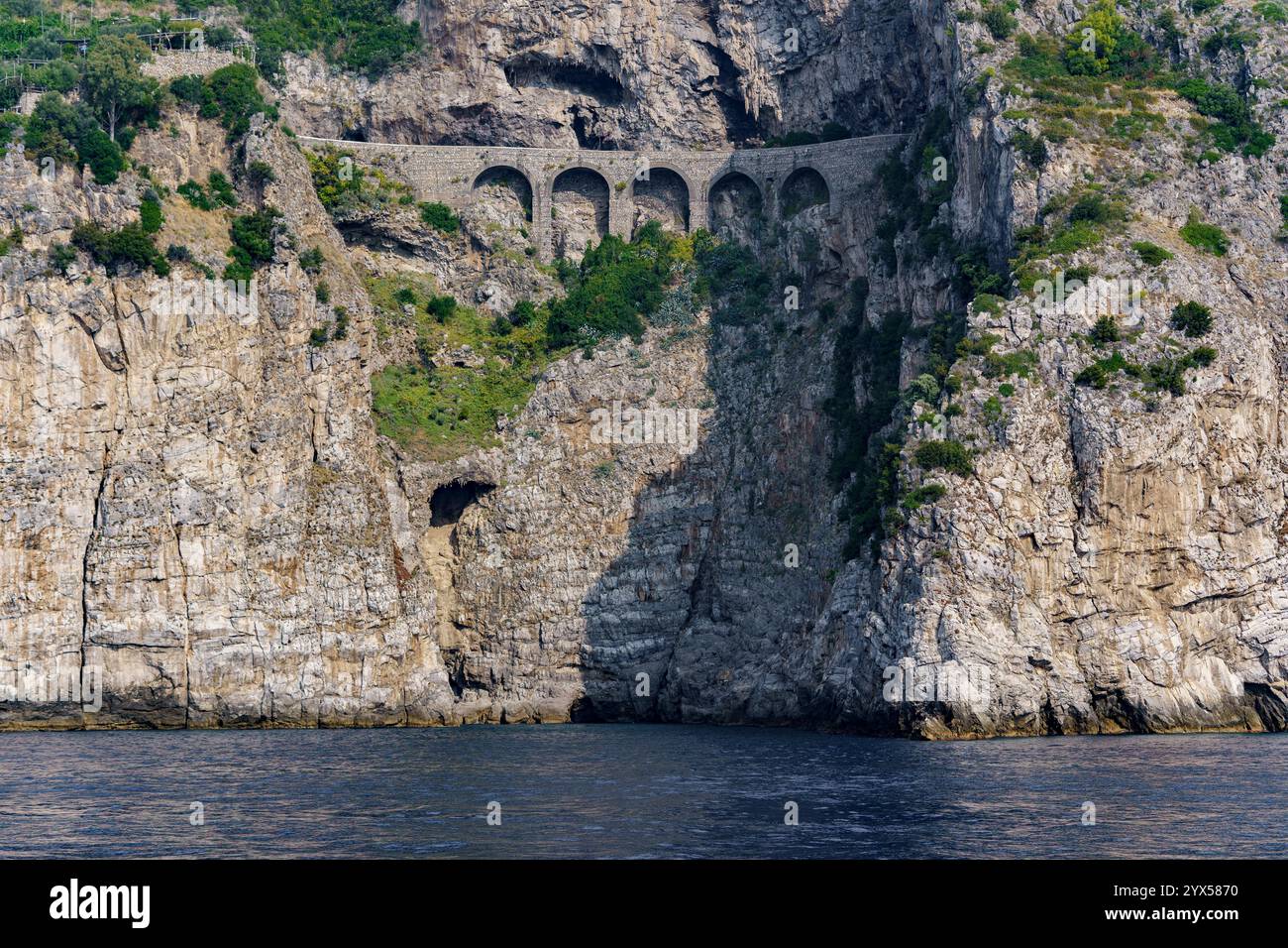 A beautiful old stone viaduct, built on the side of a steep cliff ...