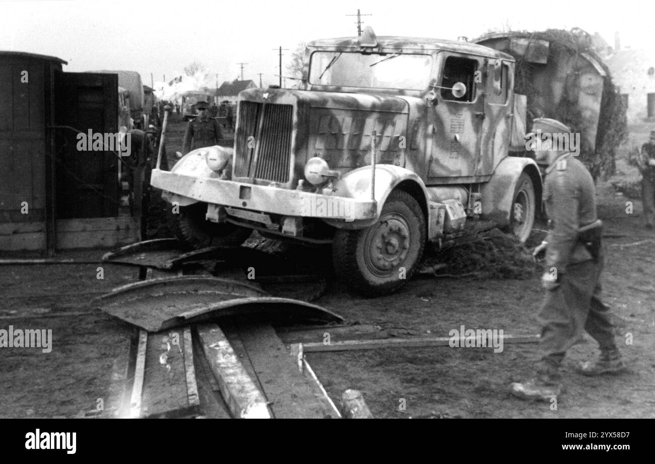 East Prussia 1944 fall, loading the map bus onto a train. A tractor ...