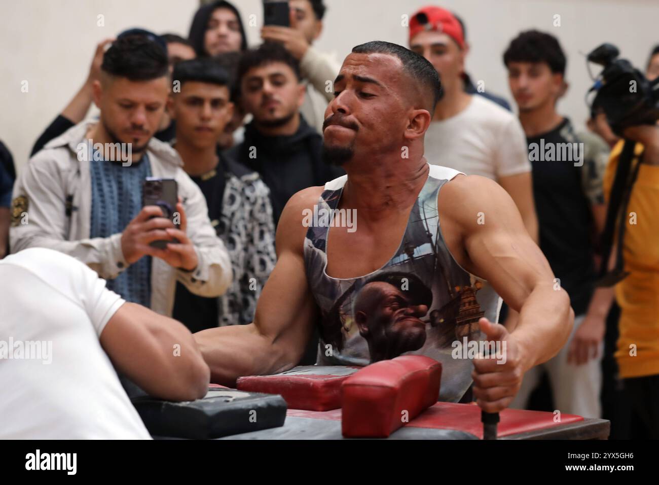 Palestinian Players compete in hand wrestling during During a championship organized by the ...