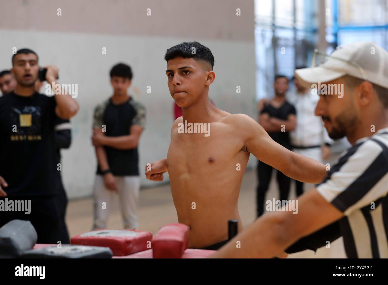 Palestinian Players compete in hand wrestling during During a championship organized by the ...