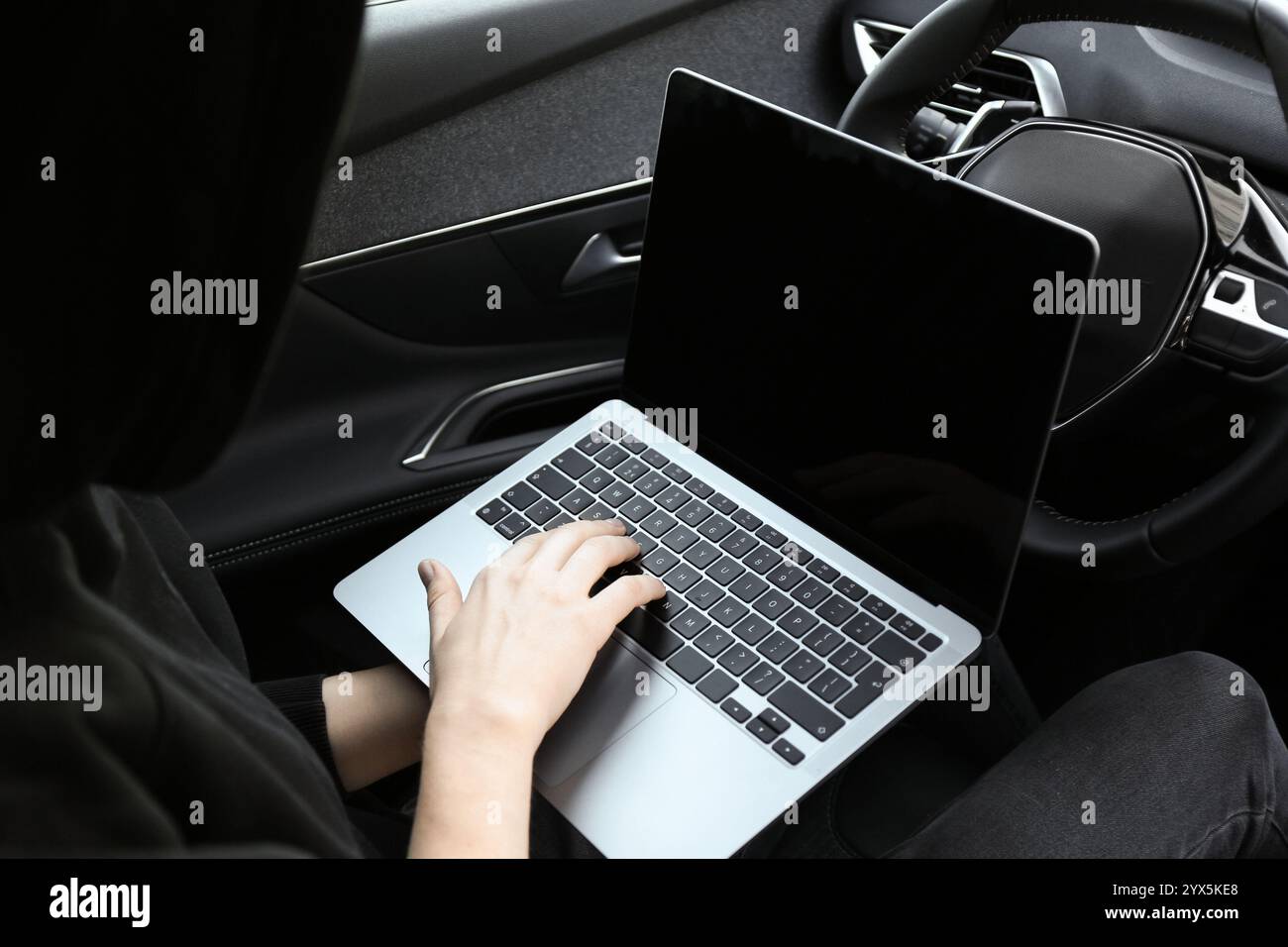 Thief hacking car system with laptop inside vehicle, closeup Stock ...