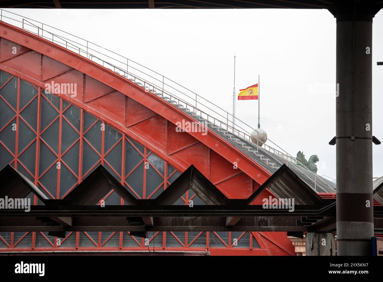 Cupola Dome detail of Atocha train station in Madrid with spanish flag. Iron constructed roof ...