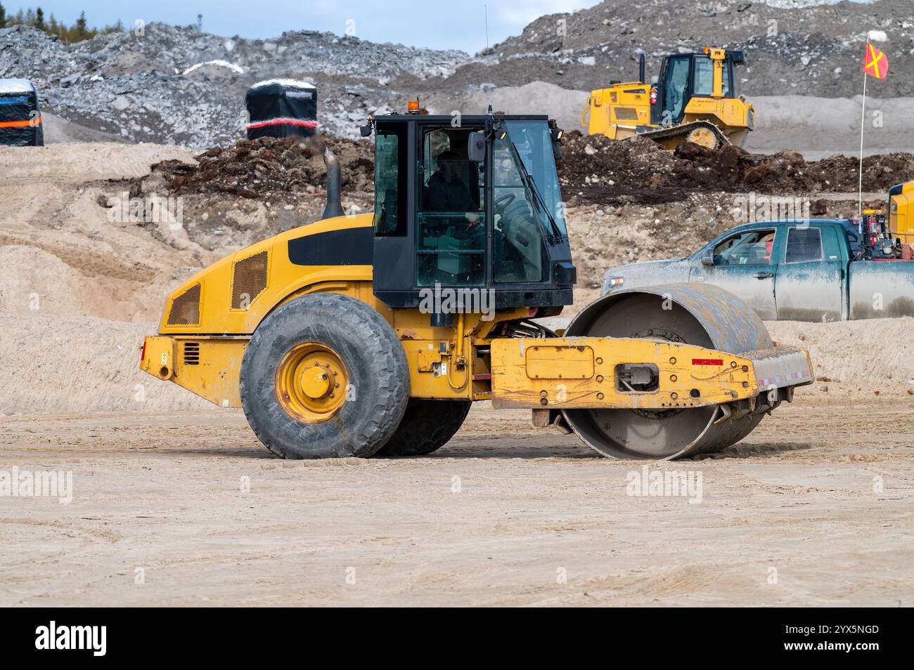 Compaction of sand in an embankment with a compactor roller Stock Photo ...