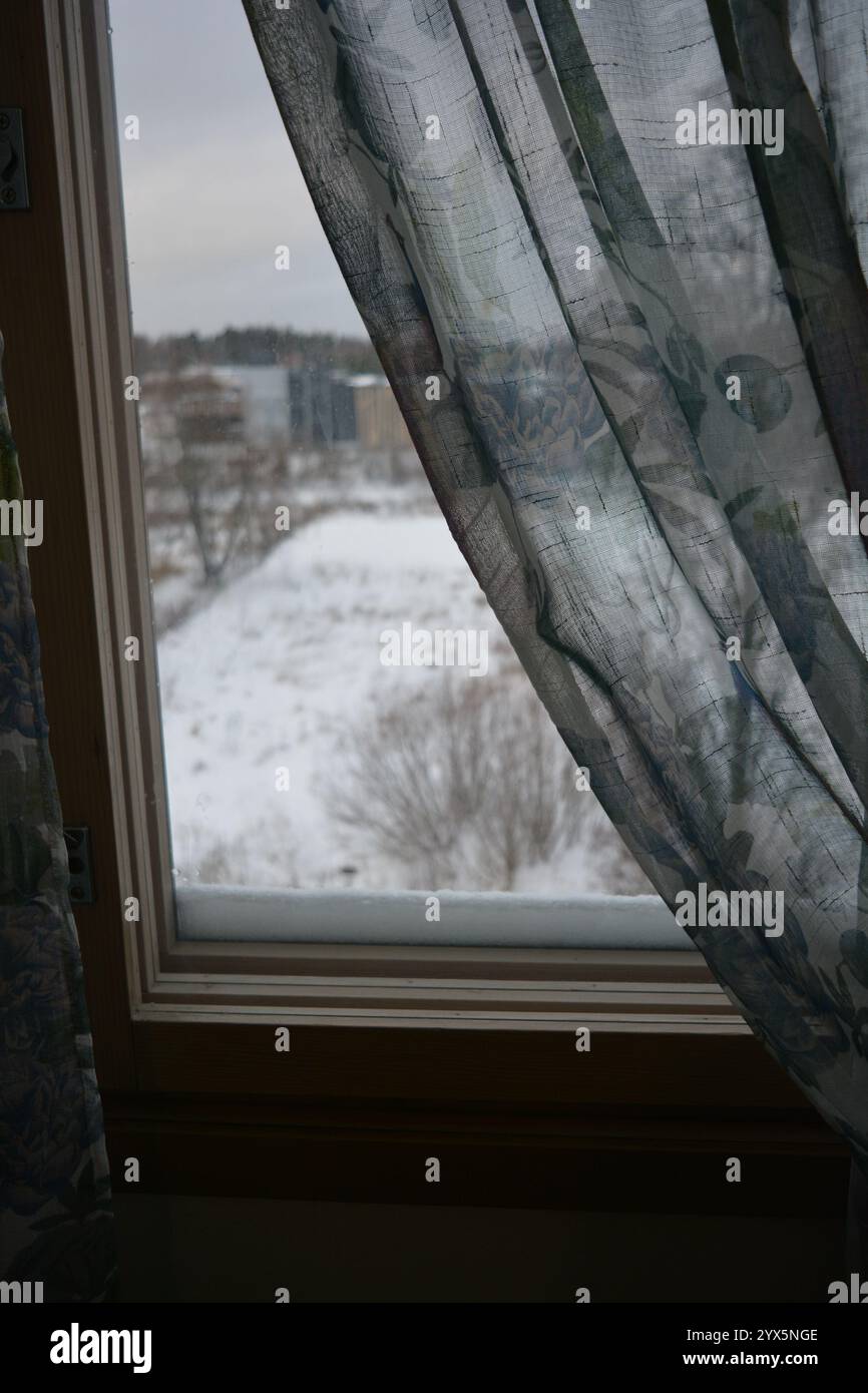 A wooden window made of natural wood is located in a Finnish house ...
