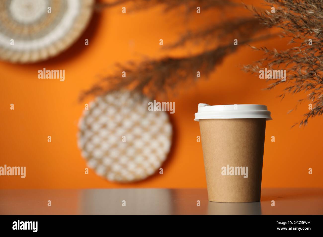 Paper cup on grey table indoors. Mockup for design Stock Photo - Alamy