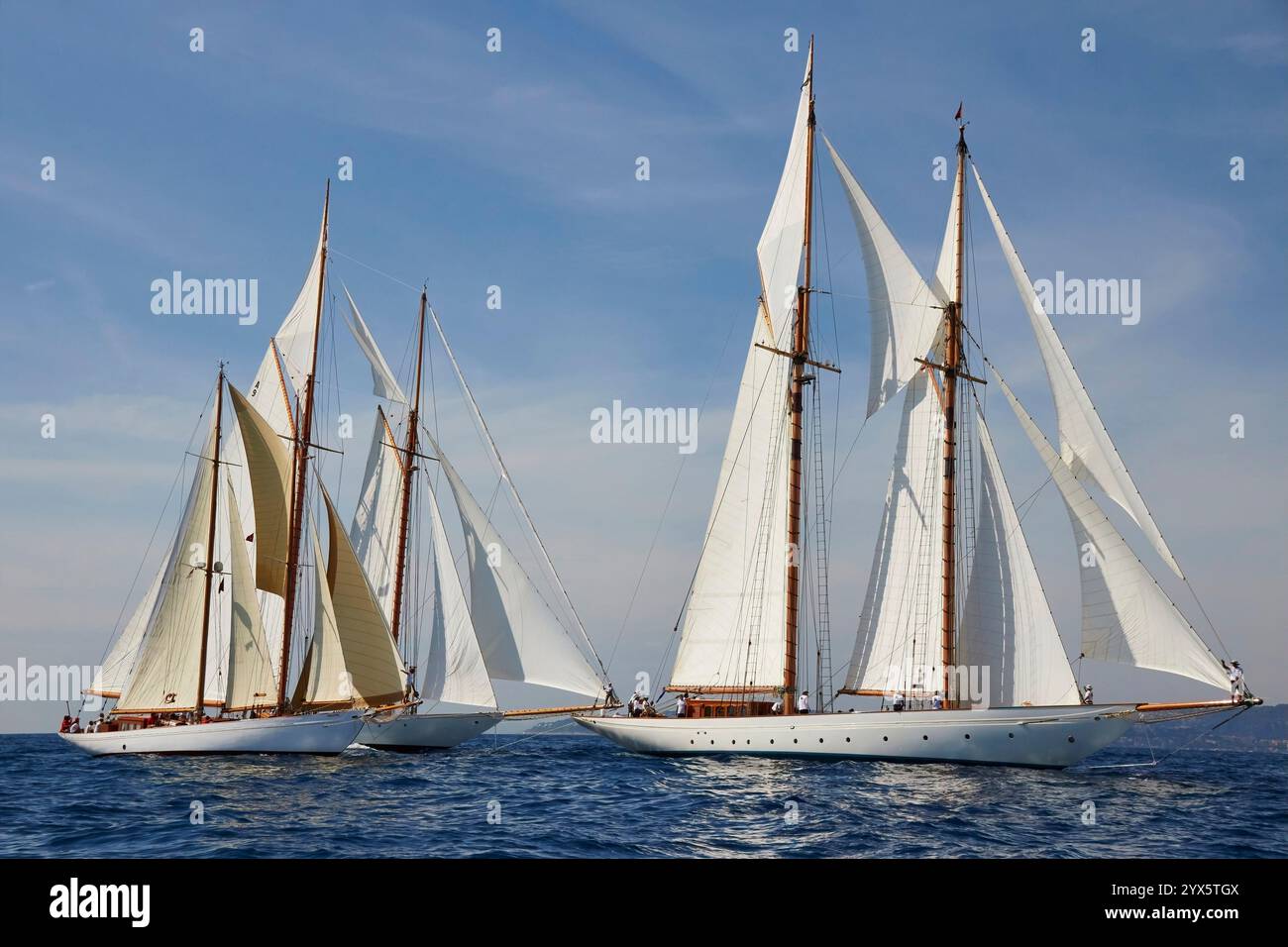 Three Traditional Sailing Yachts on Open Sea Under Blue Sky Stock Photo ...