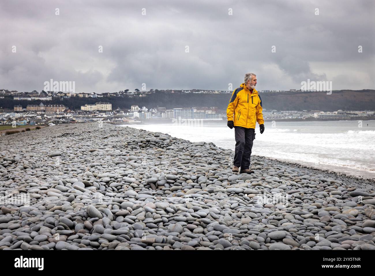 A lone walker takes a stroll along the pebble rifge at Westward Ho ...