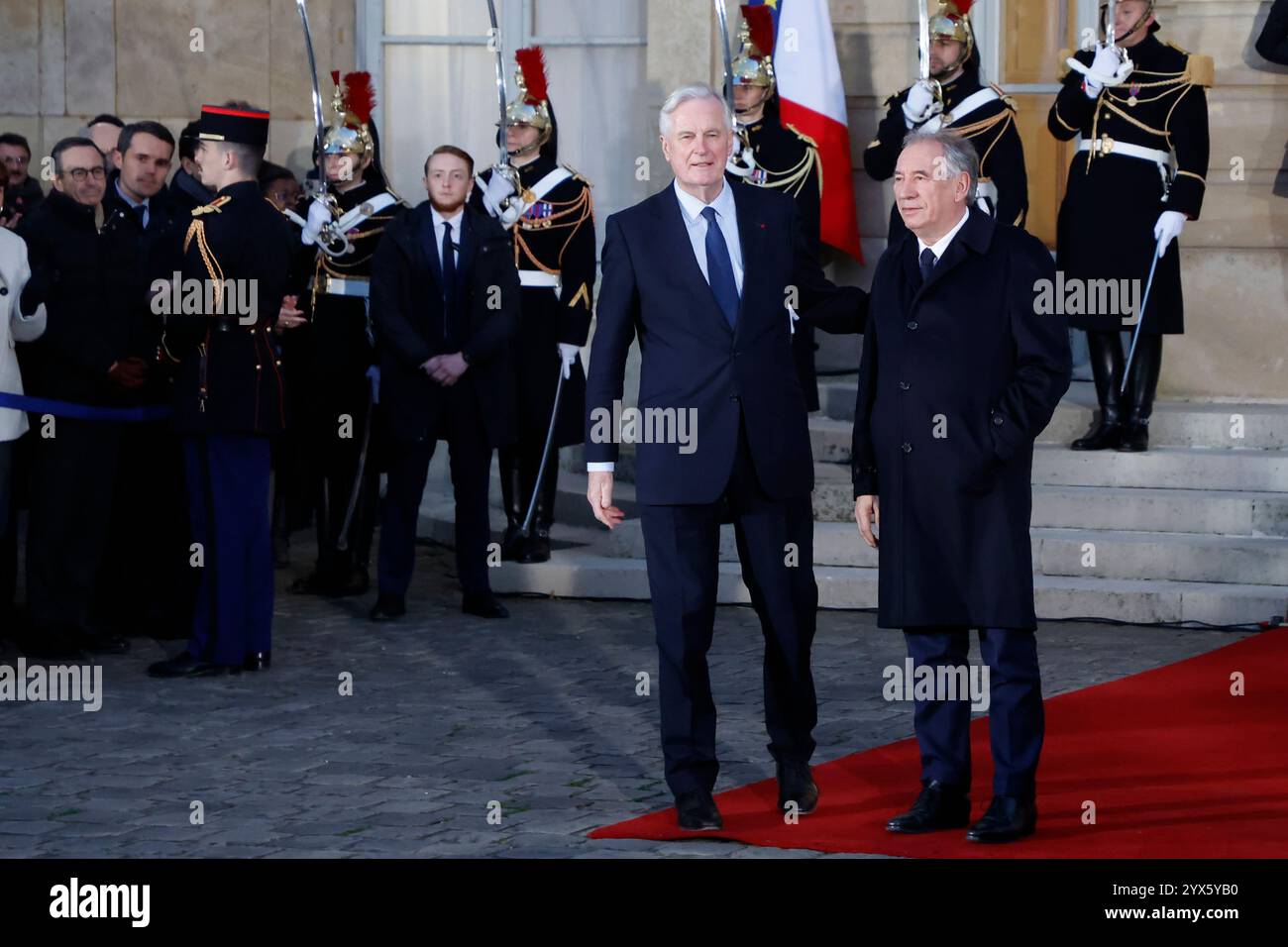 Paris, France. 13th Dec, 2024. Francois Bayrou (R, Front) and outgoing ...