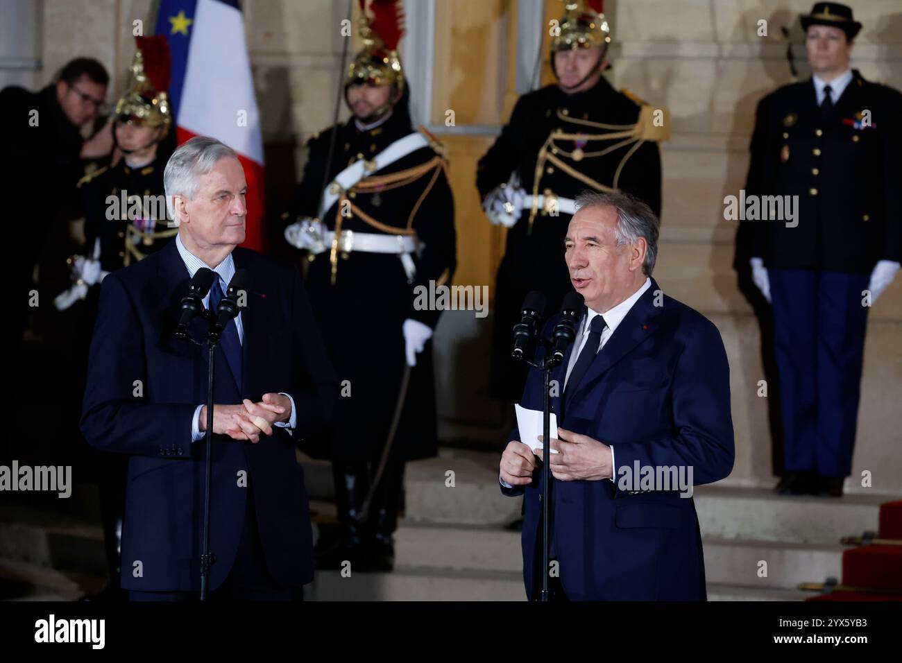 Paris, France. 13th Dec, 2024. Francois Bayrou (R, Front) and outgoing ...