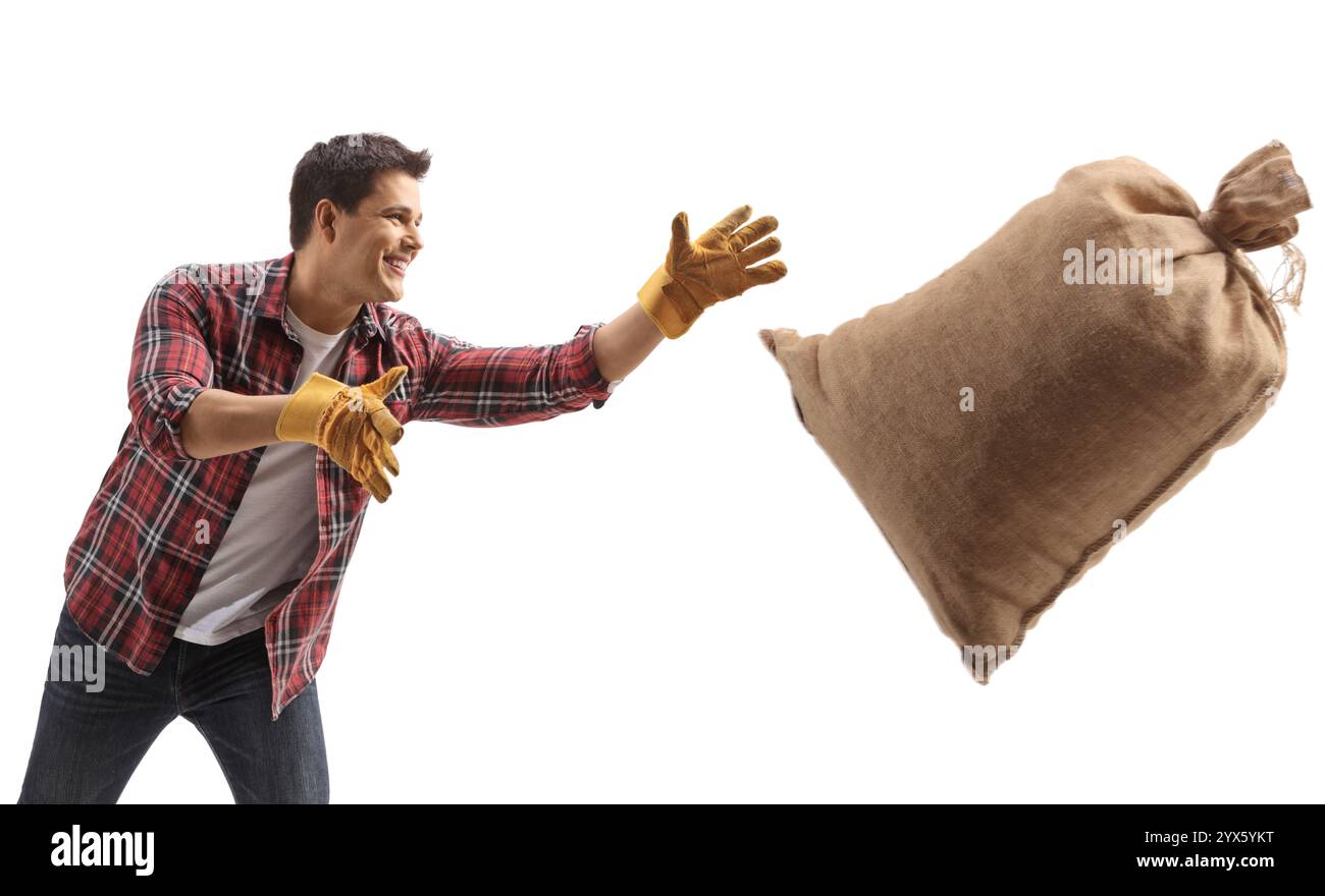Farmer throwing a burlap sack isolated on white background Stock Photo ...