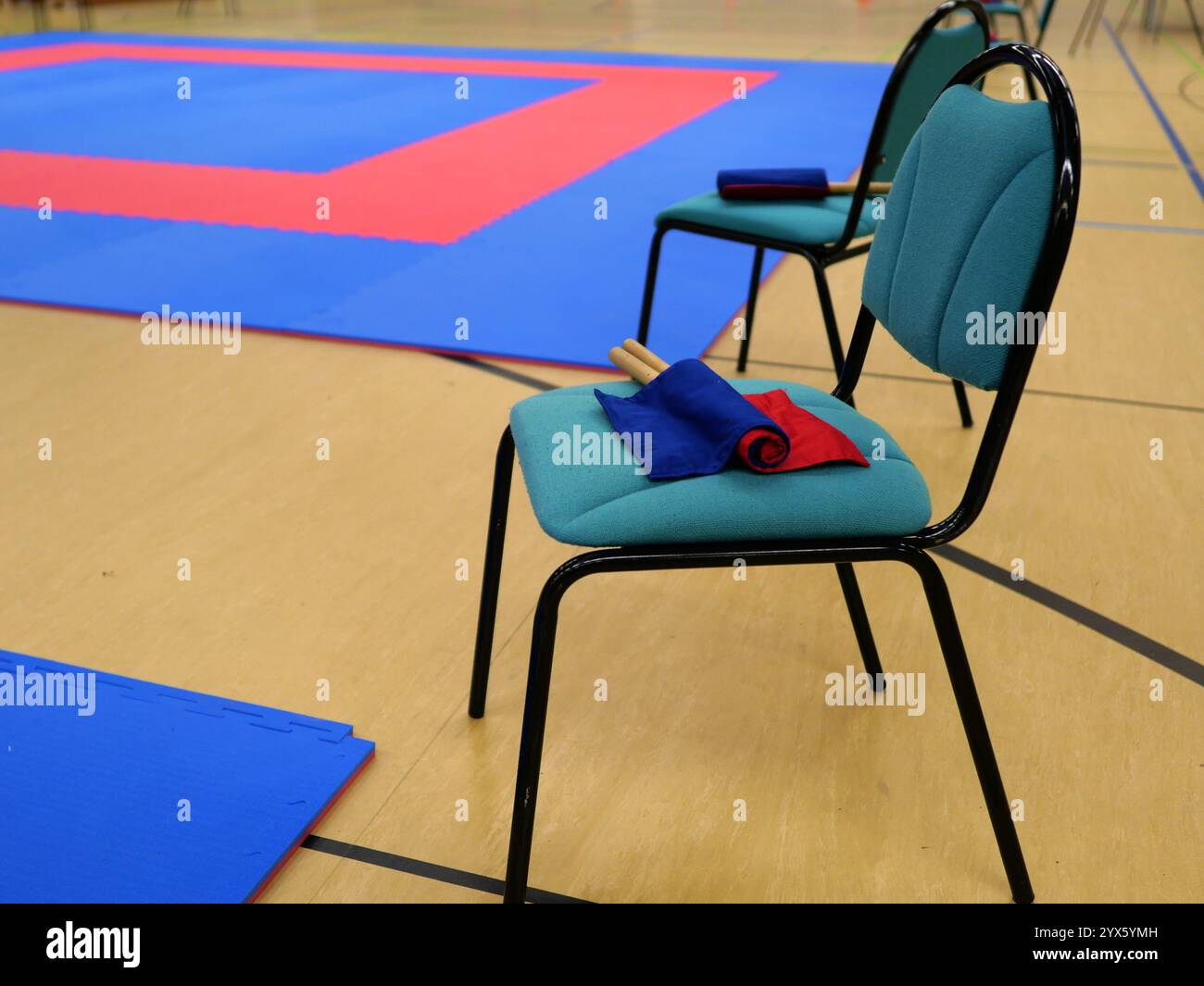 A chair with blue-red flags in front of a tatami in a sports hall ...