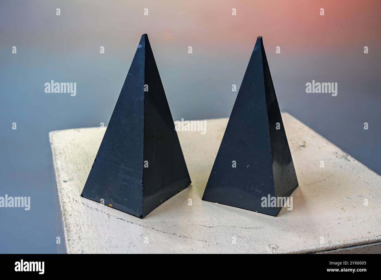 Minimalist composition: two black pyramids on a light background Stock ...