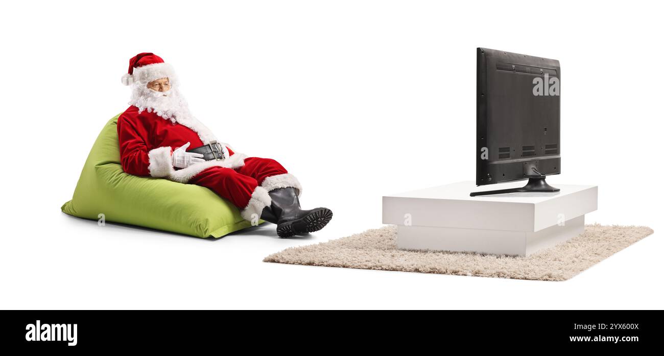 Santa Claus sitting in a beanbag and watching television isolated on ...