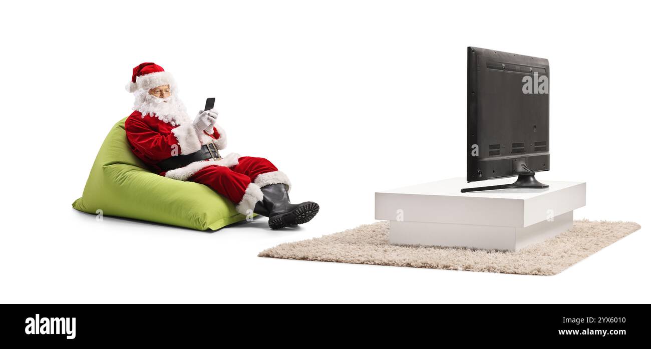 Santa Claus sitting in a beanbag and using a smartphone in front of tv ...