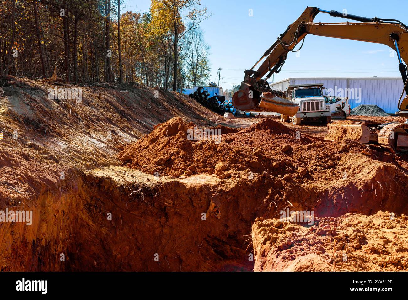 Heavy excavator is moving, excavating dirt at construction site during ...