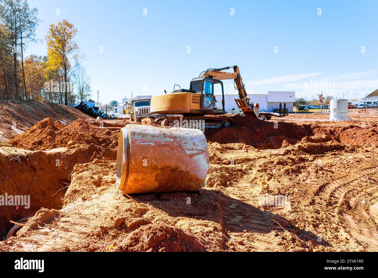 Heavy machinery operates at construction site, moving earth preparing ...