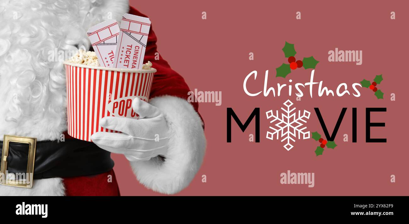 Santa Claus with bucket of popcorn and cinema tickets on pink ...