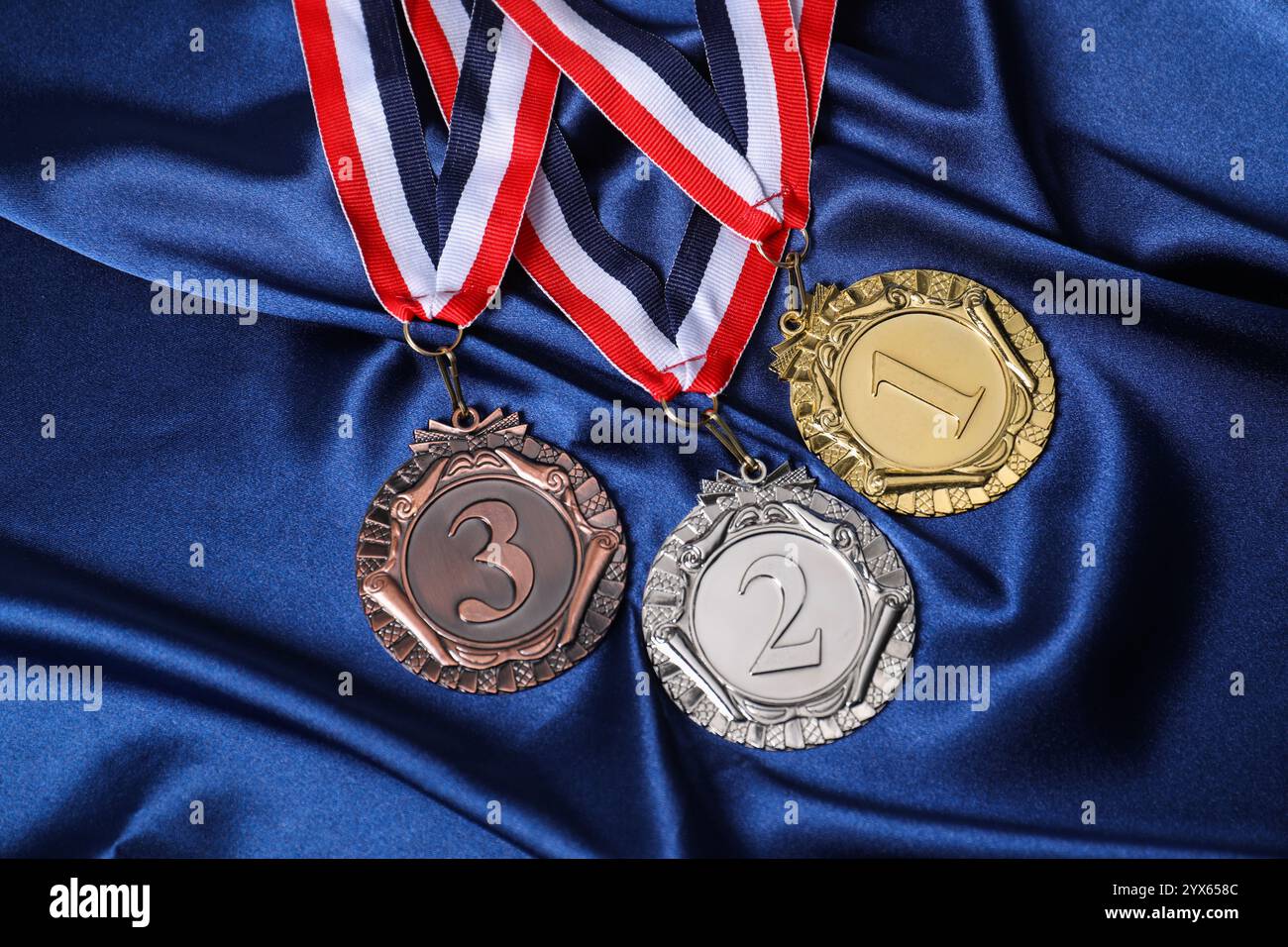 Golden, silver and bronze medals on blue fabric, above view Stock Photo ...