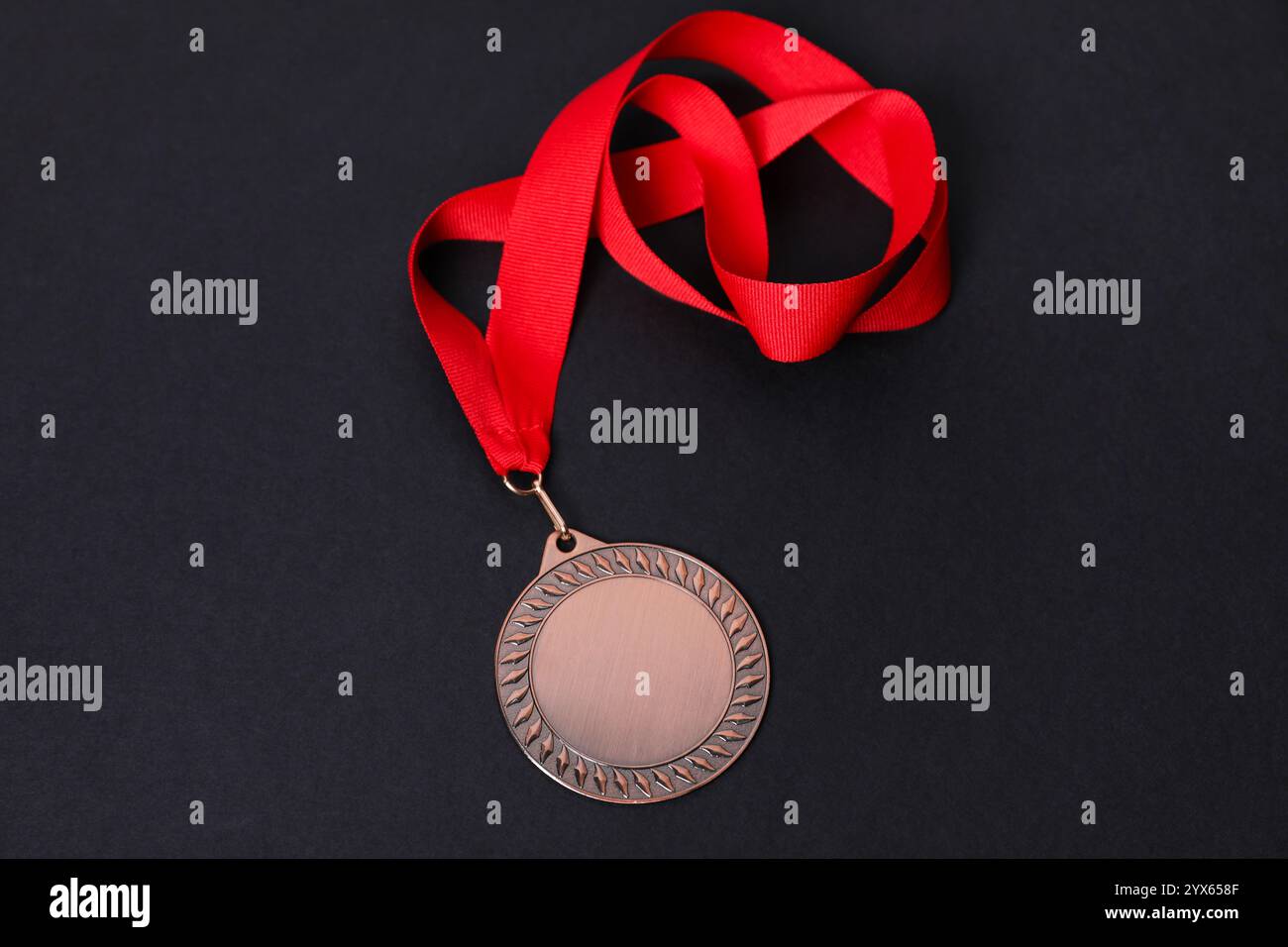 Bronze medal with red ribbon on black background, above view Stock ...