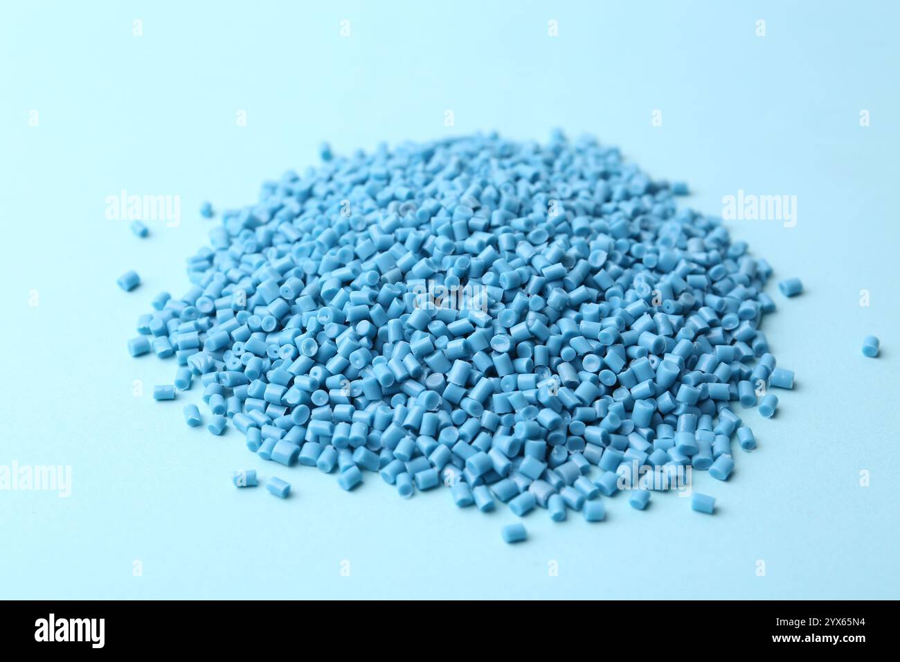 Pile of plastic granules on light blue background, closeup Stock Photo ...