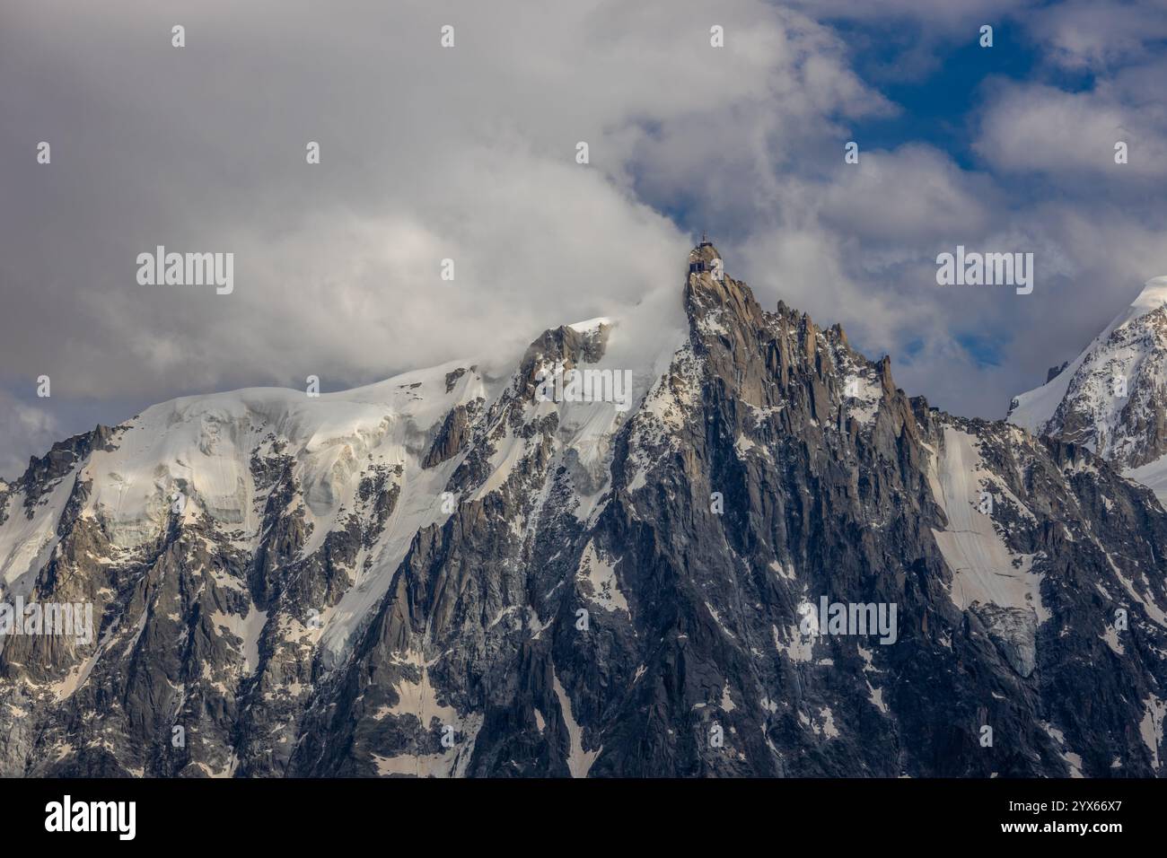 Aiguille du Midi peak in the Alps. Chamonix valley landscape of a prominent rocky towering ...