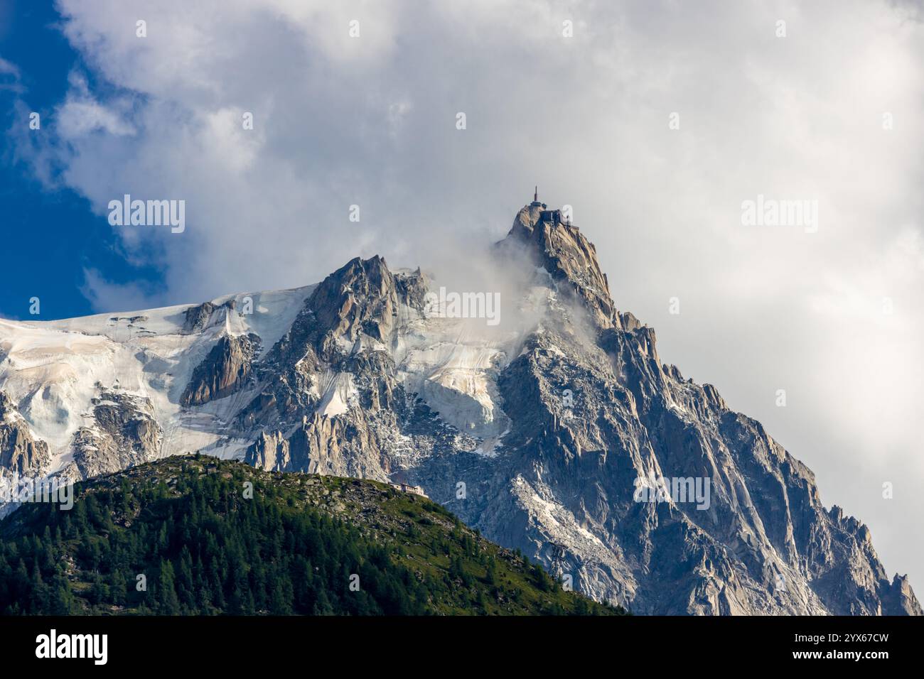 Aiguille du Midi peak in the Alps. Chamonix valley landscape of a prominent rocky towering ...