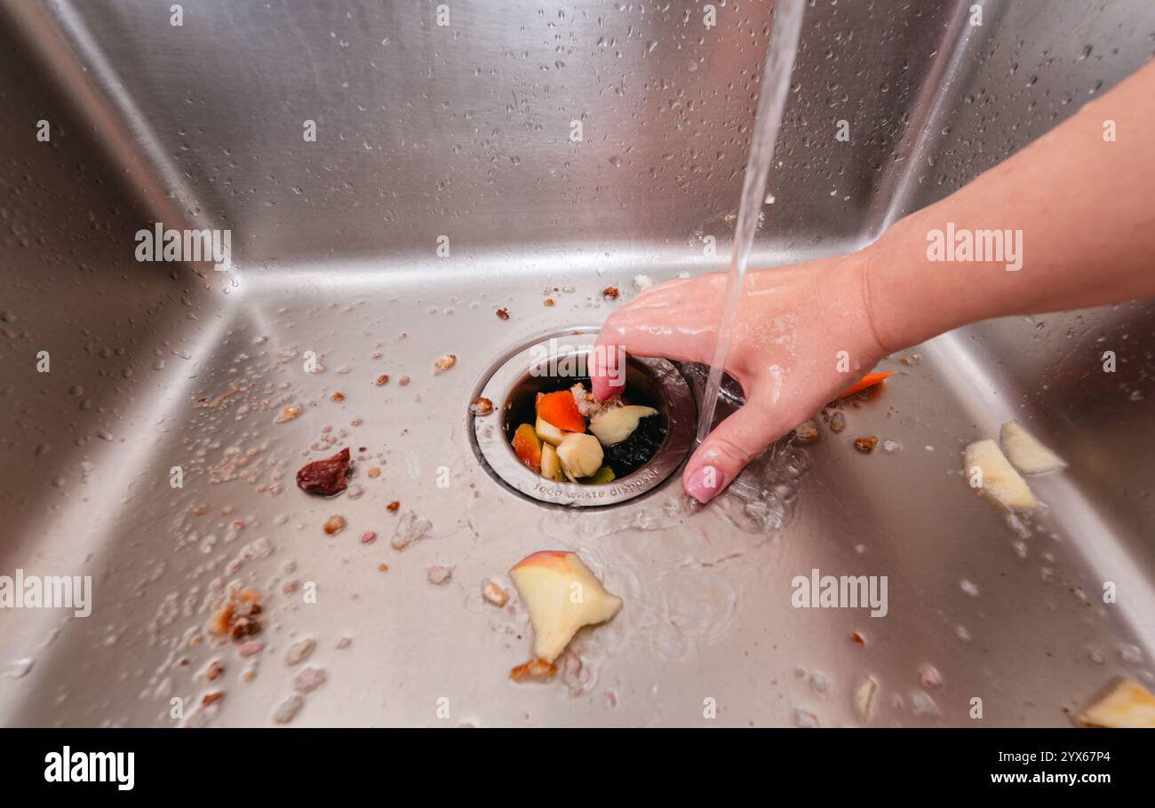 Proper food waste disposal demonstrated with a sink garbage disposal ...