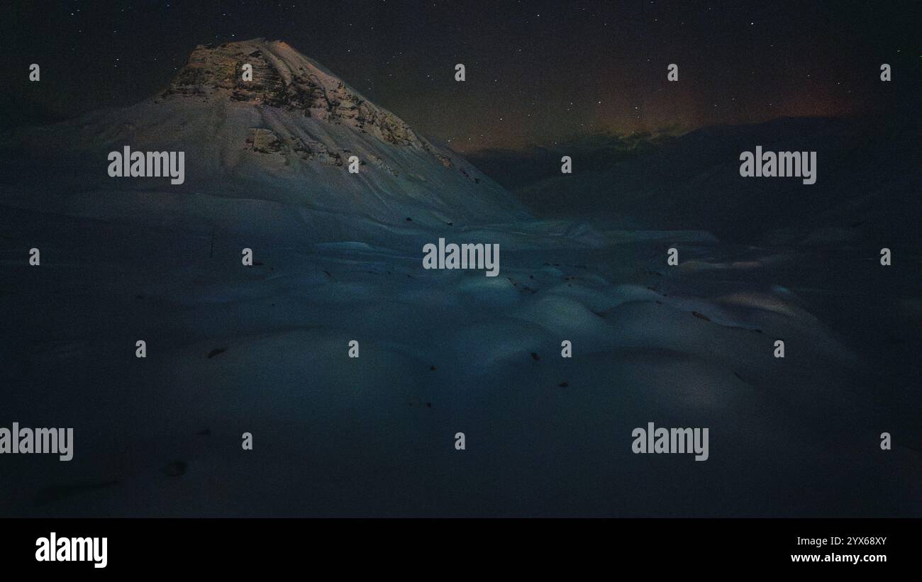 Northern lights over snowy valley in Longyearbyen, Svalbard polar night ...