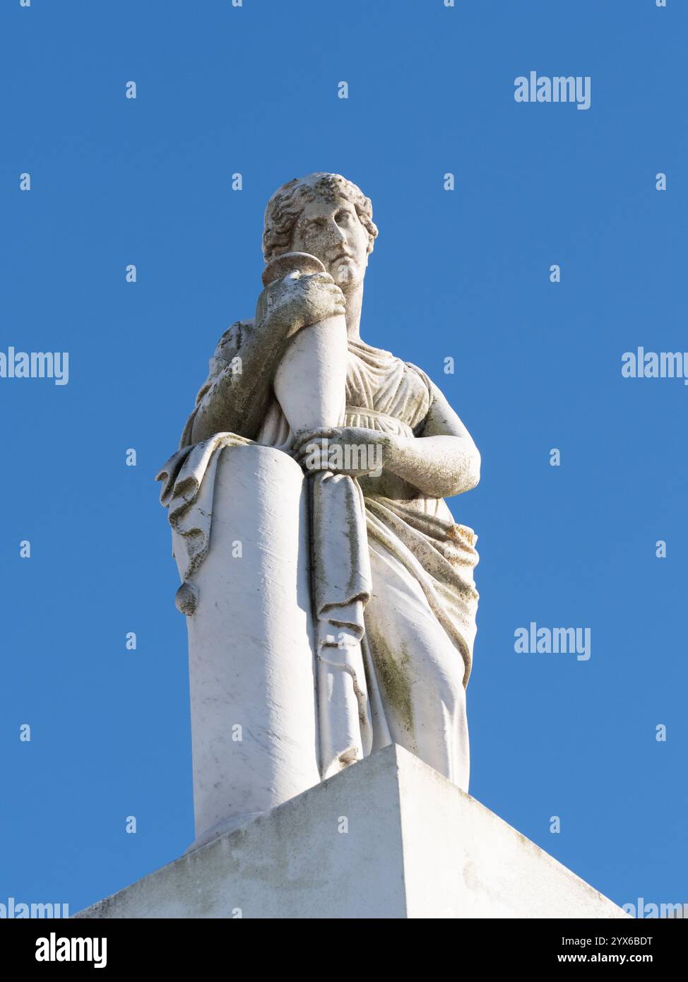 Weathered and stained statue of an ancient Greek woman holding an urn ...
