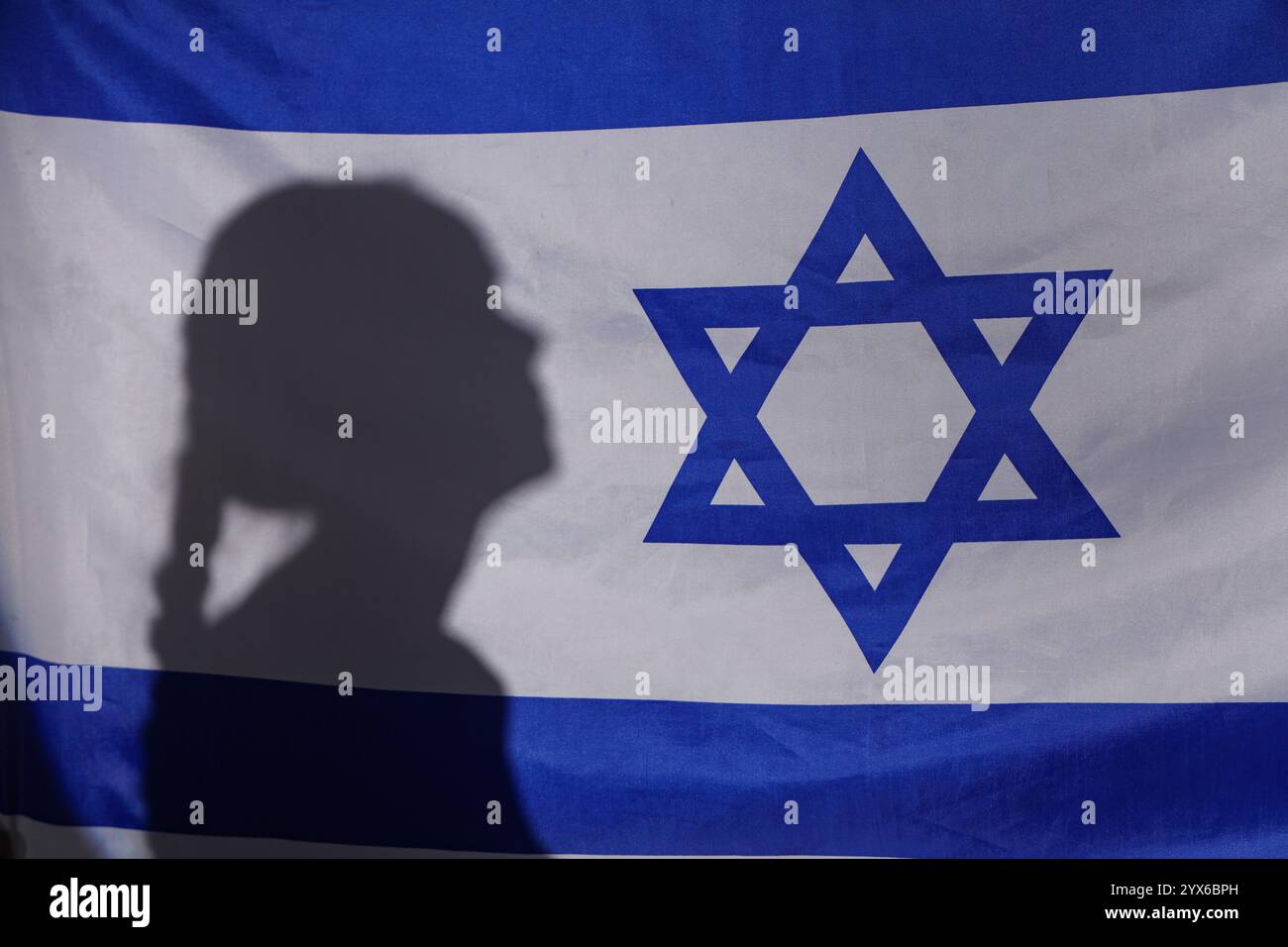 Shadow of little Jewish girl on flag of Israel. International Holocaust ...