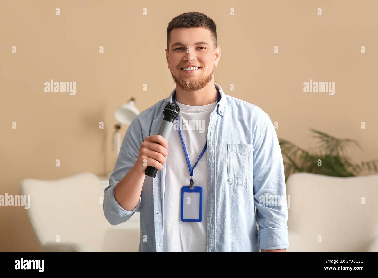 Male reporter with microphone and blank name tag in studio Stock Photo ...