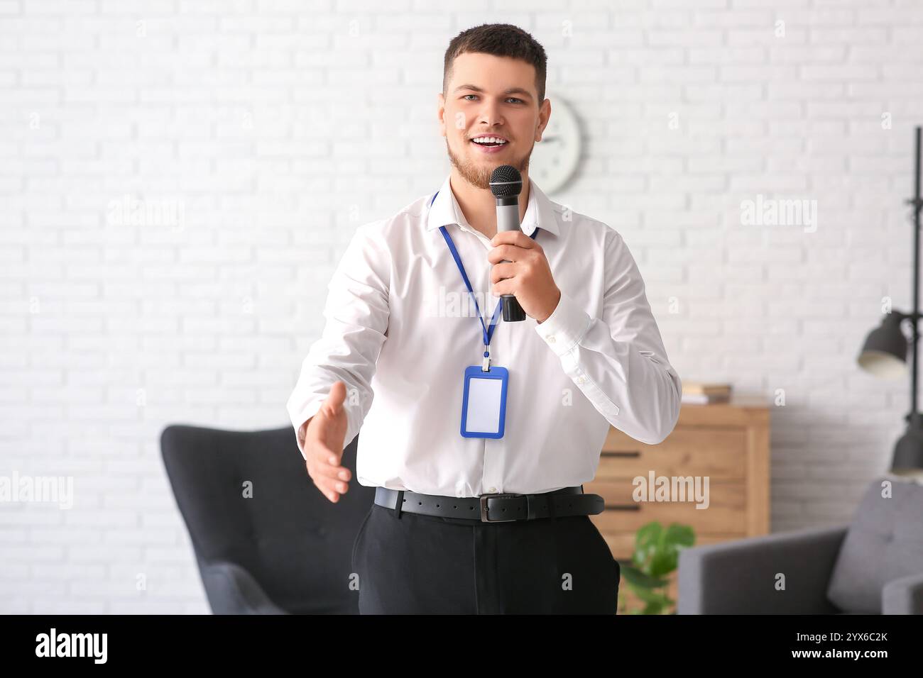 Male reporter with microphone and blank name tag extending hand for ...