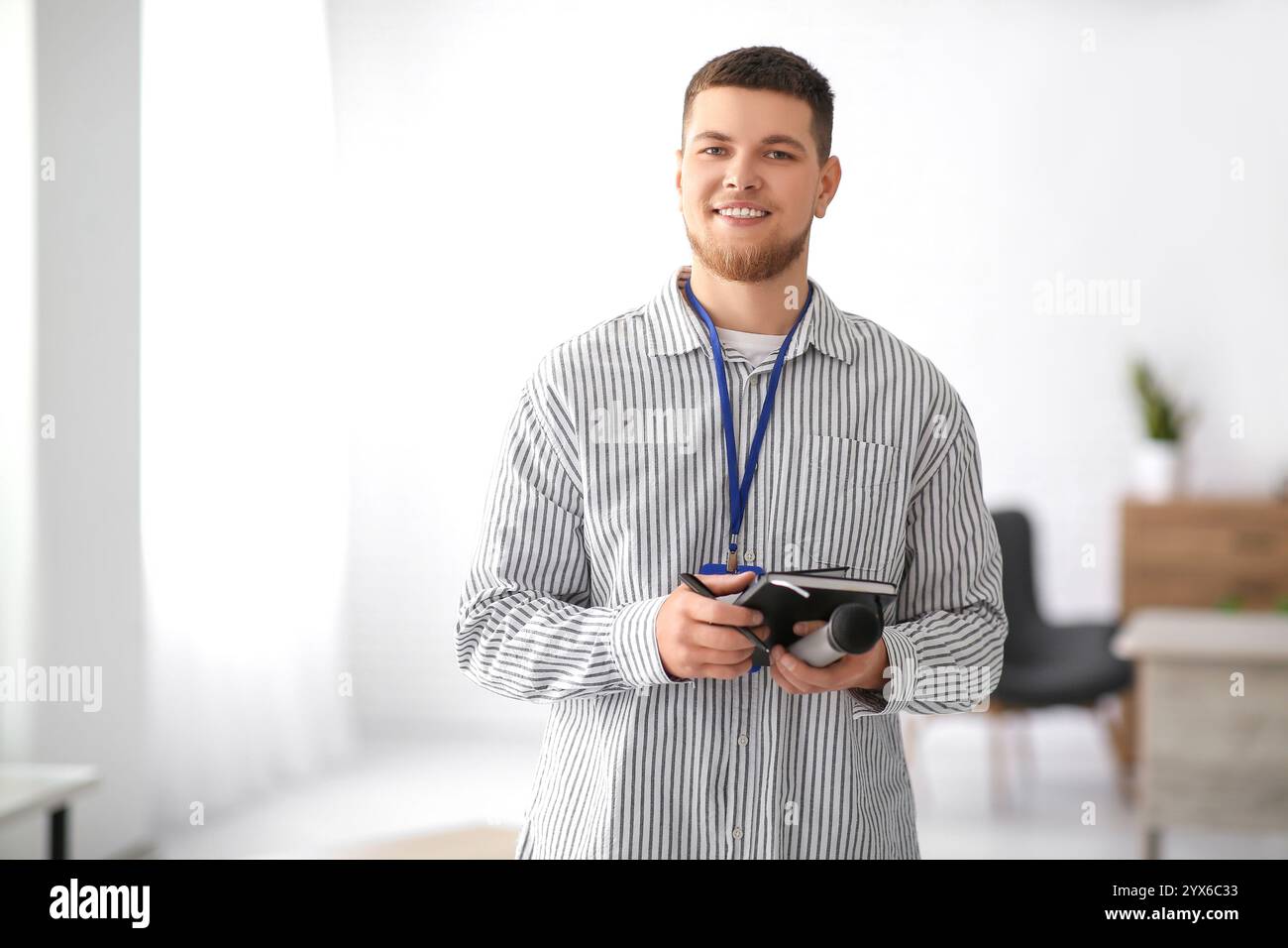 Male reporter with microphone, notebooks and name tag in studio Stock ...