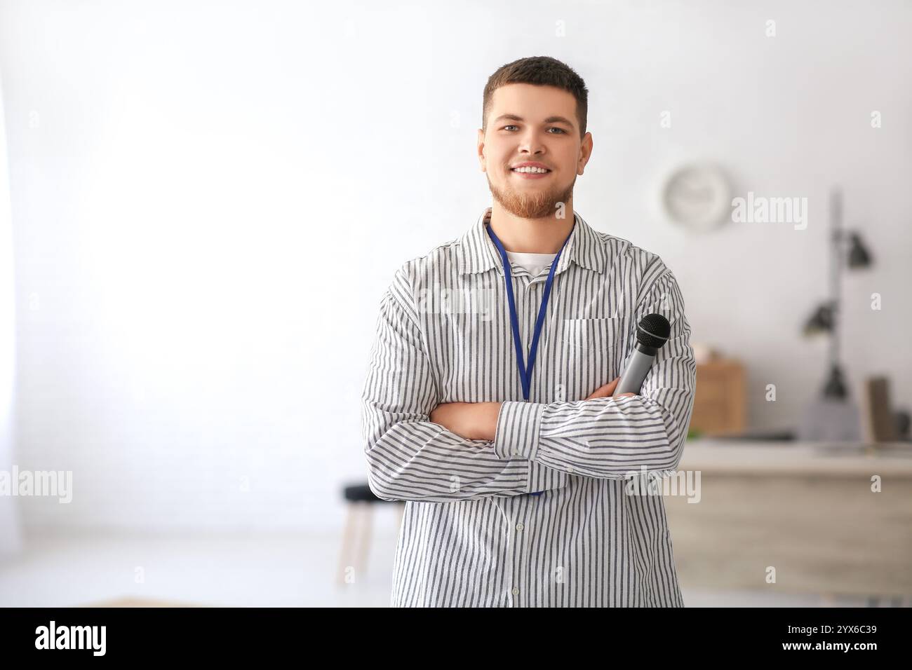 Male reporter with microphone and name tag in studio Stock Photo - Alamy