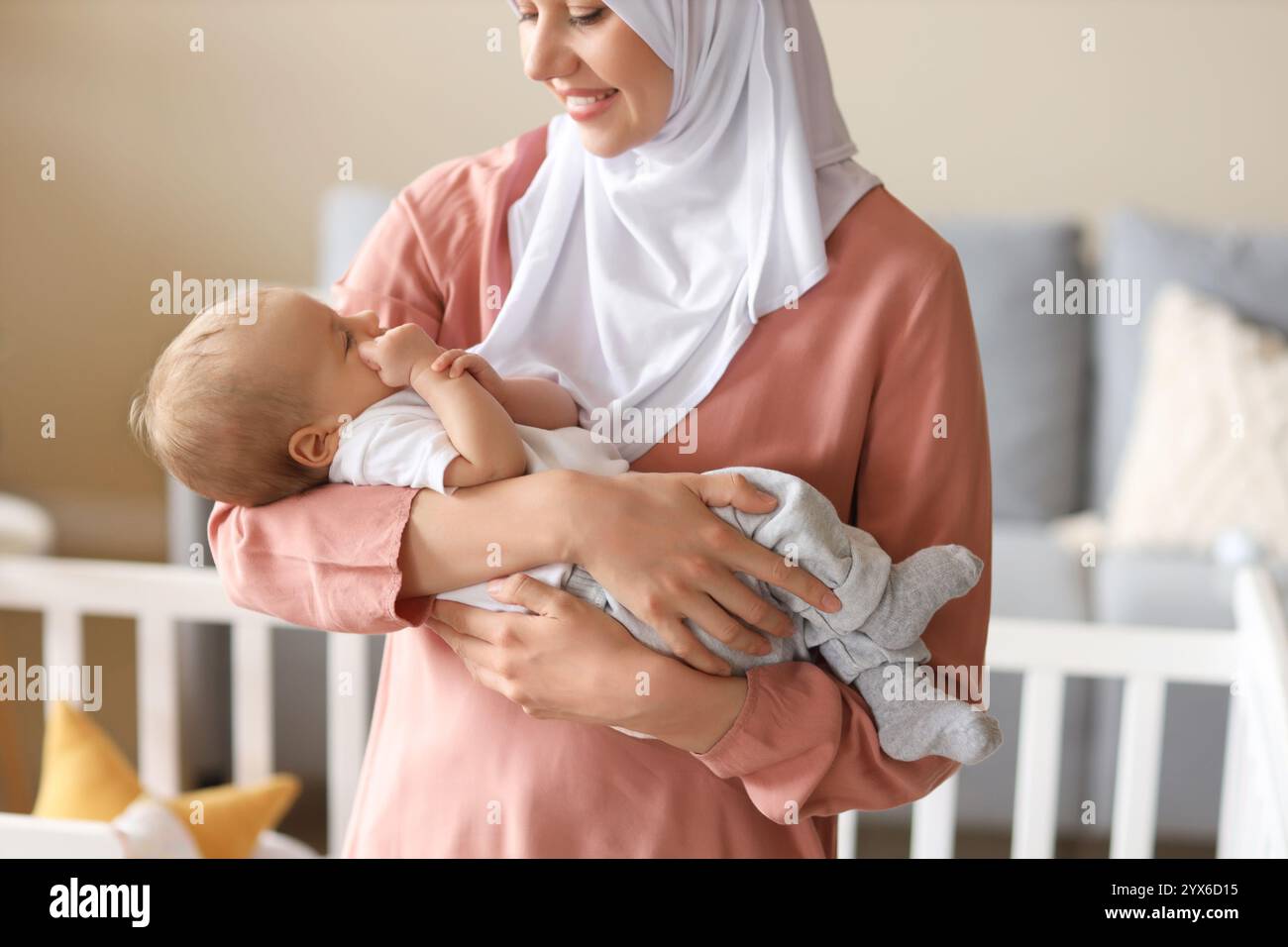 Happy Muslim mother in hijab with cute little baby at home Stock Photo ...