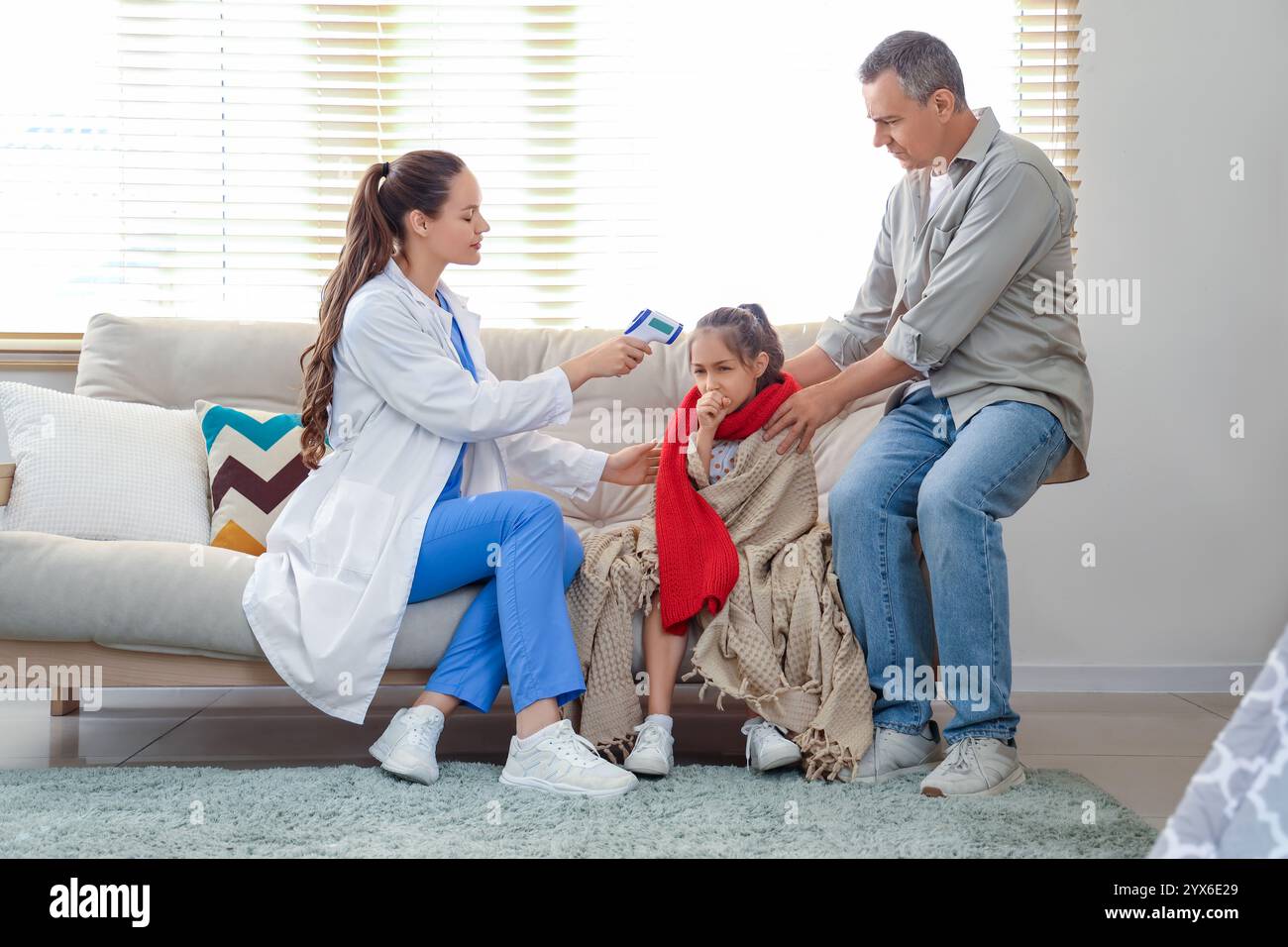 Female pediatrician measuring sick little girl's temperature and father at home Stock Photo - Alamy