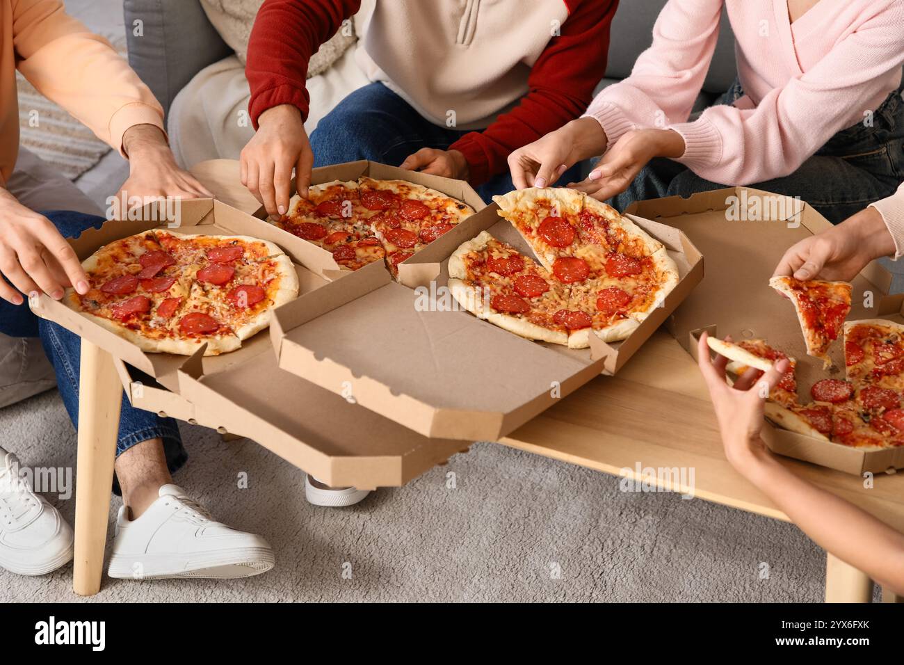 Friends eating pepperoni pizza at home, closeup Stock Photo - Alamy