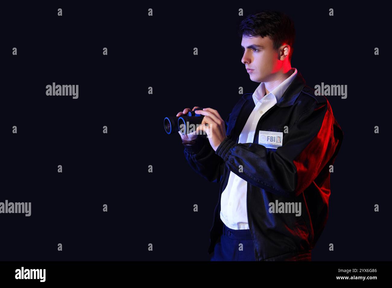 Male FBI agent with binoculars on dark background Stock Photo - Alamy