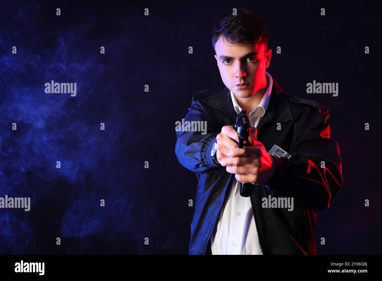 Male FBI agent with gun on dark background Stock Photo - Alamy