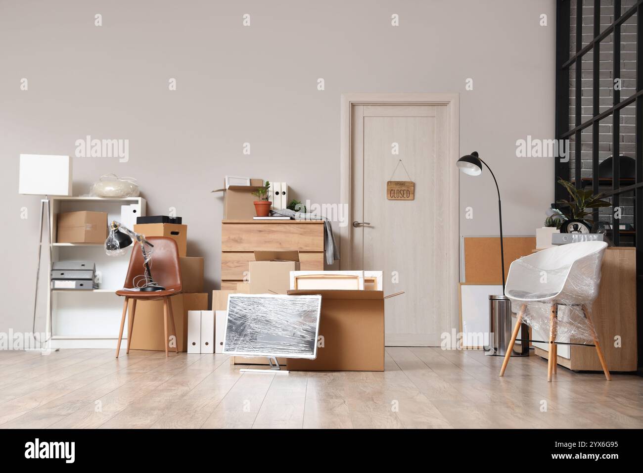 Interior of modern office with cardboard boxes, furniture and monitor ...