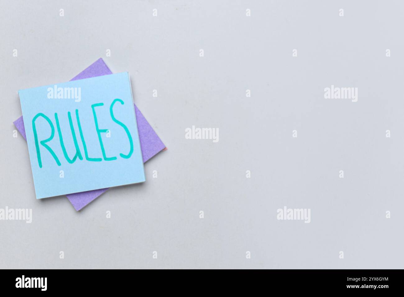 Sticky notes with word RULES on light background Stock Photo - Alamy
