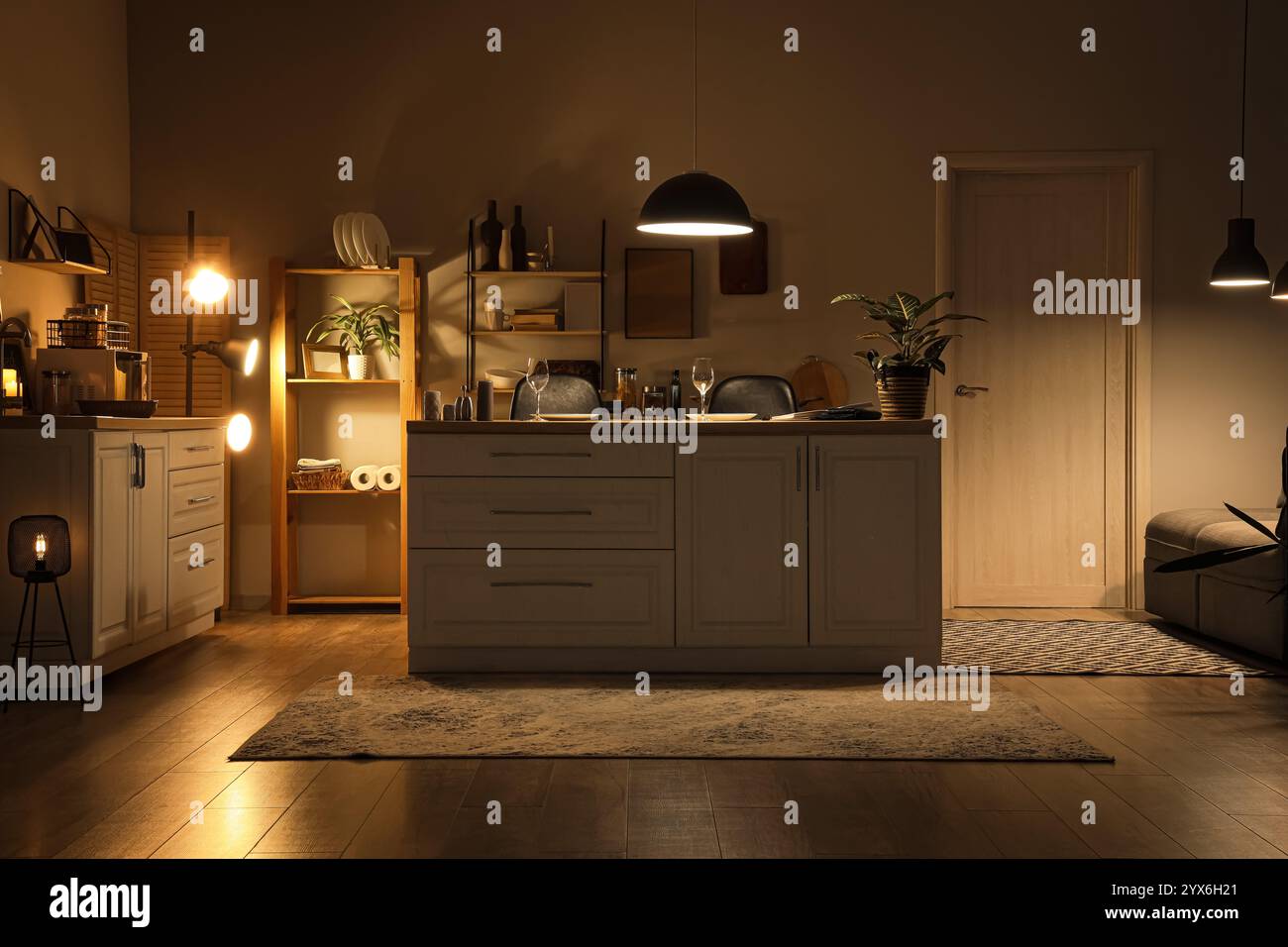Interior of dark kitchen with counters, shelves and glowing lamps at ...