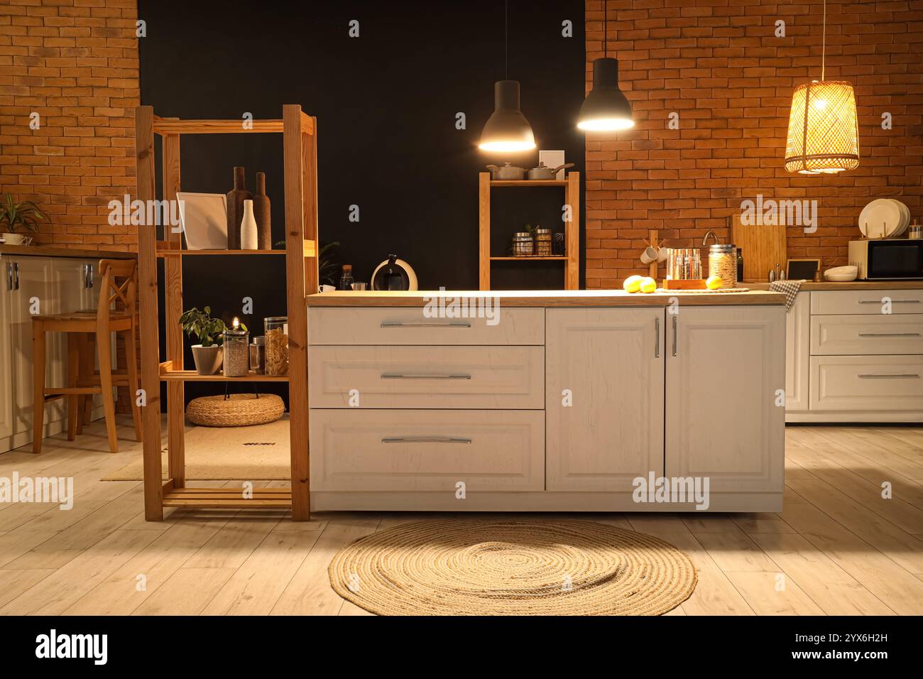 Interior of kitchen with white counters, shelf units and glowing lamps ...