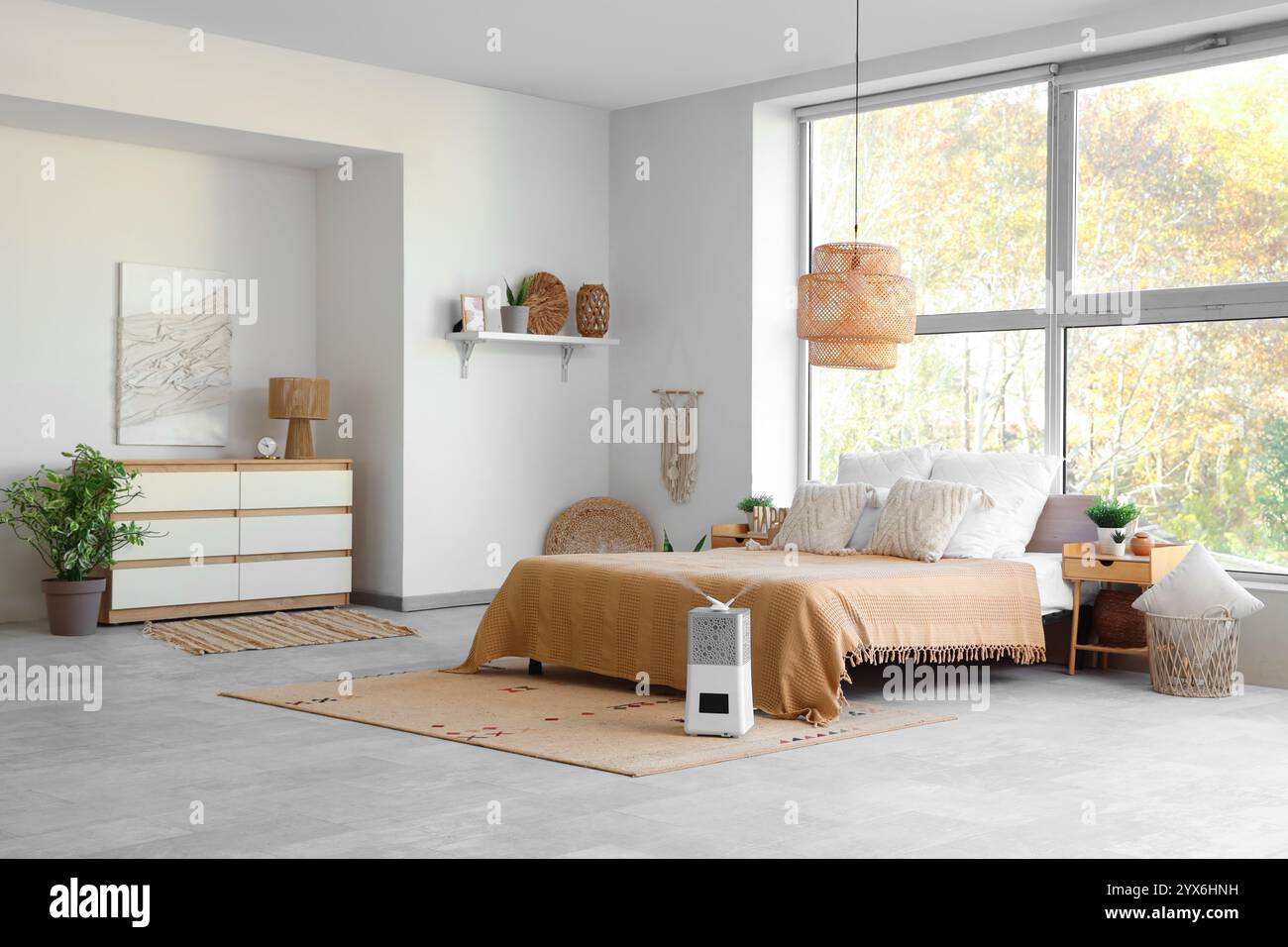 Modern air humidifier on carpet in bedroom interior Stock Photo - Alamy
