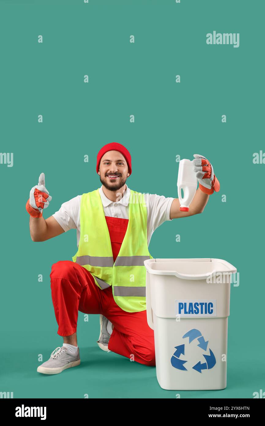 Male scavenger showing thumb-up with plastic garbage and trash bin on ...