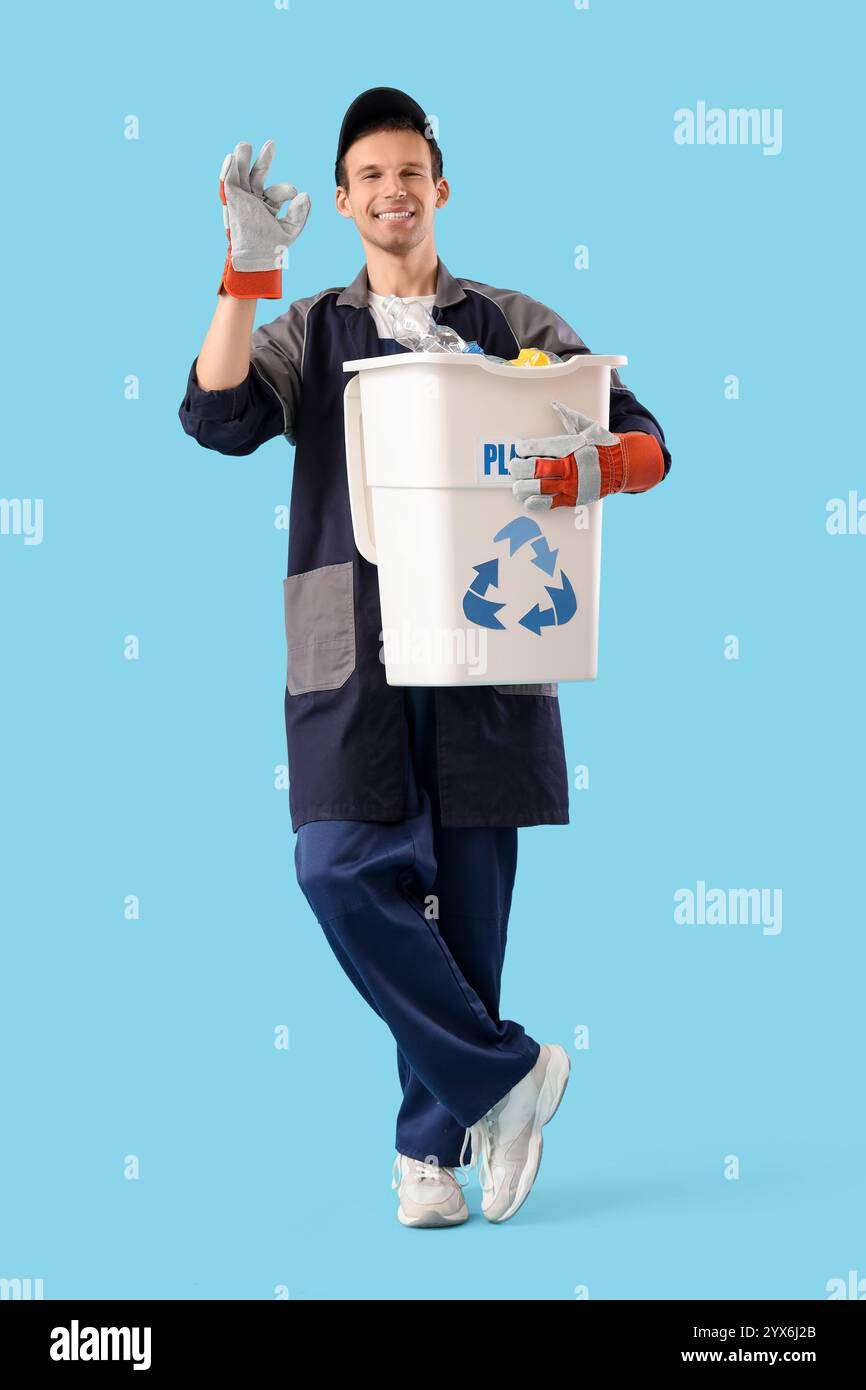 Male scavenger with recycle trash bin showing OK on blue background ...