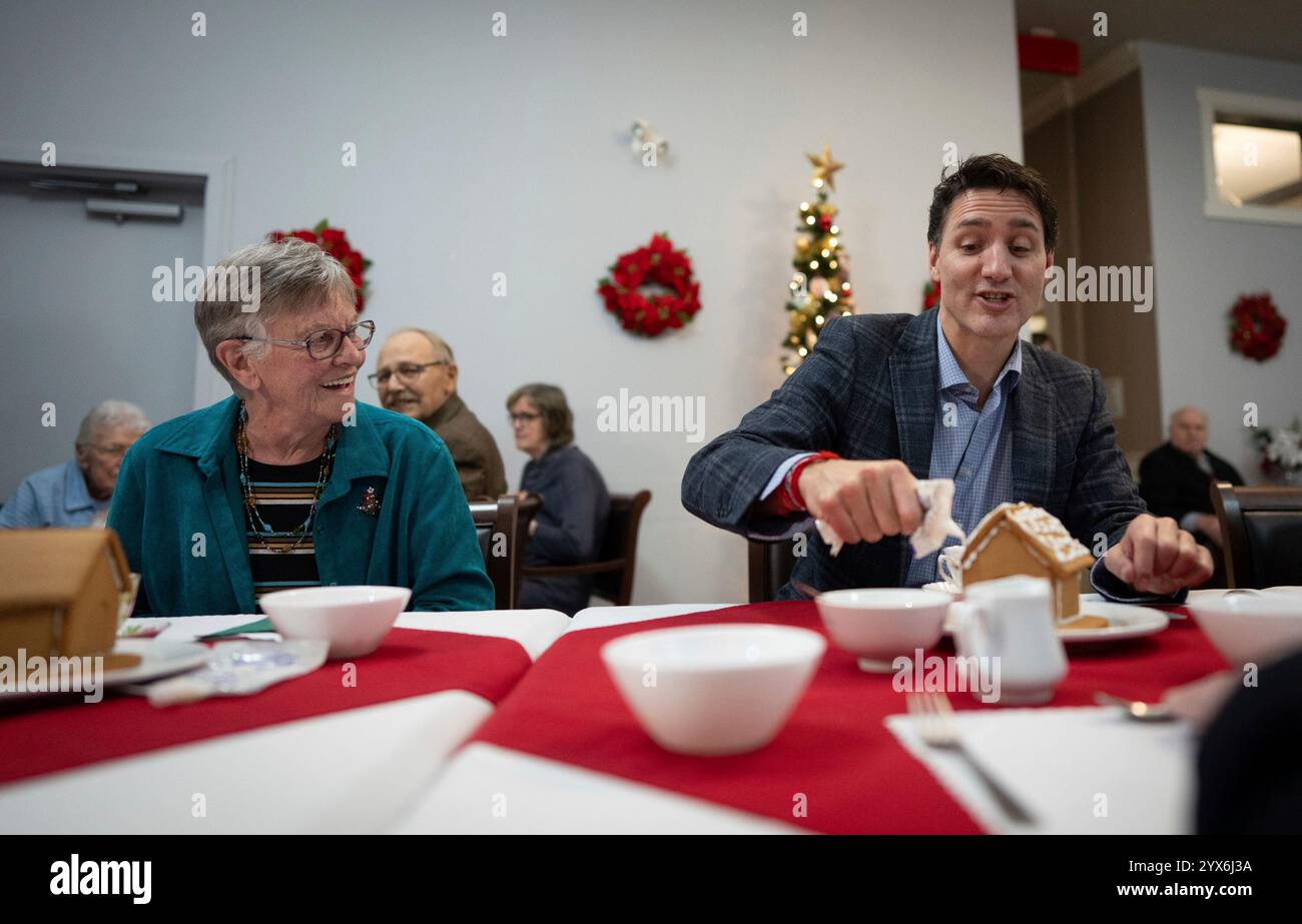 Canada's Prime Minister Justin Trudeau decorates a gingerbread house ...
