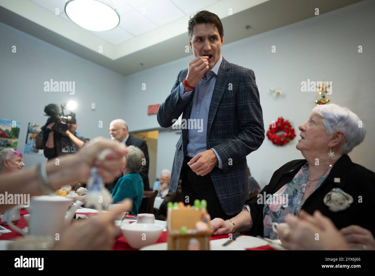 Prime Minister Justin Trudeau eats a piece of candy off of a ...