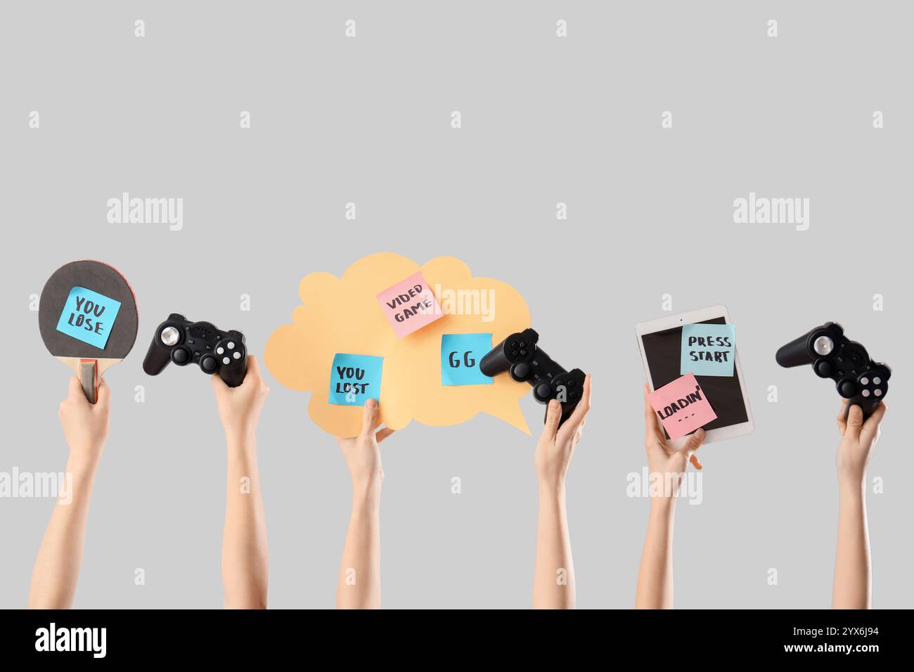 Female hands with game pads, sticky papers, tablet computer and ping ...
