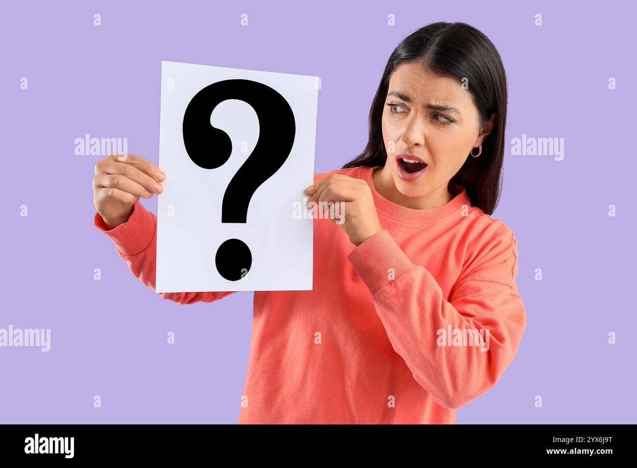 Shocked young woman with paper question mark on lilac background Stock ...